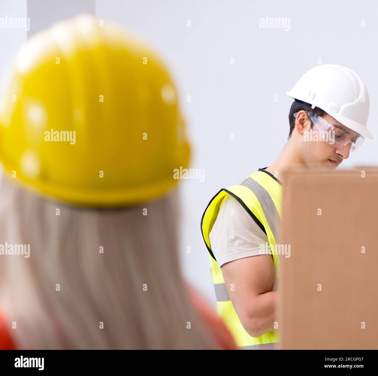 The delivery contractor delivering boxes to office Stock Photo - Alamy