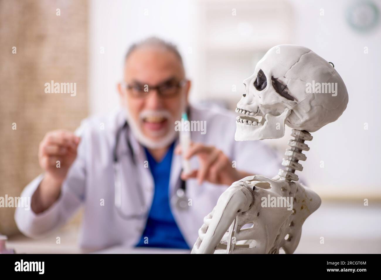 Old doctor examining skeleton at the hospital Stock Photo - Alamy