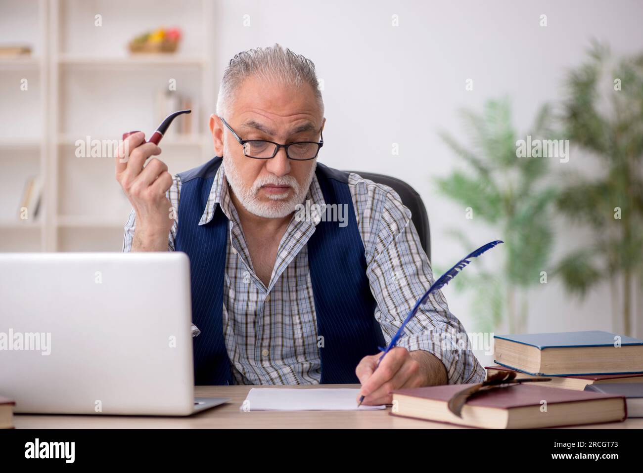 Old writer sitting at workplace Stock Photo - Alamy