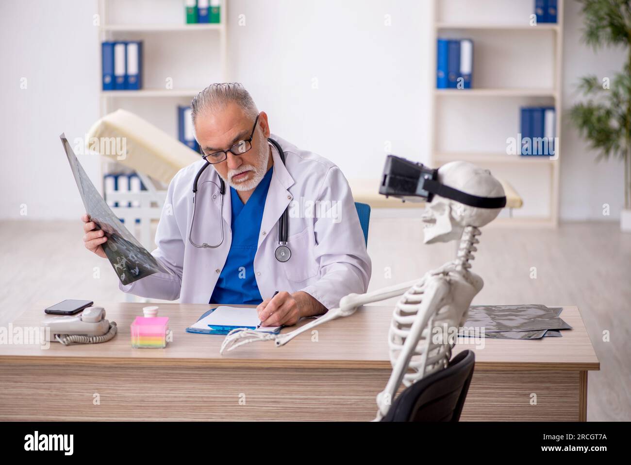 Old doctor examining skeleton at the hospital Stock Photo - Alamy