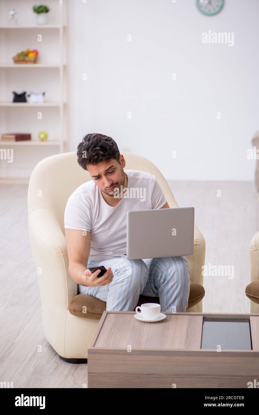 Young lazy man starting day at home Stock Photo - Alamy