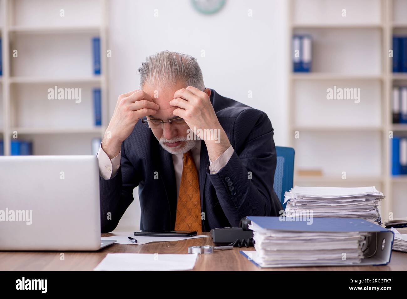 Old employee working in the office Stock Photo - Alamy