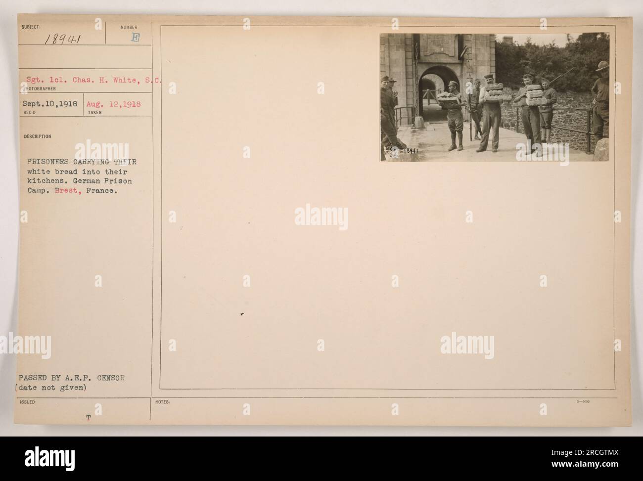German prisoners carrying loaves of white bread into their kitchens at ...