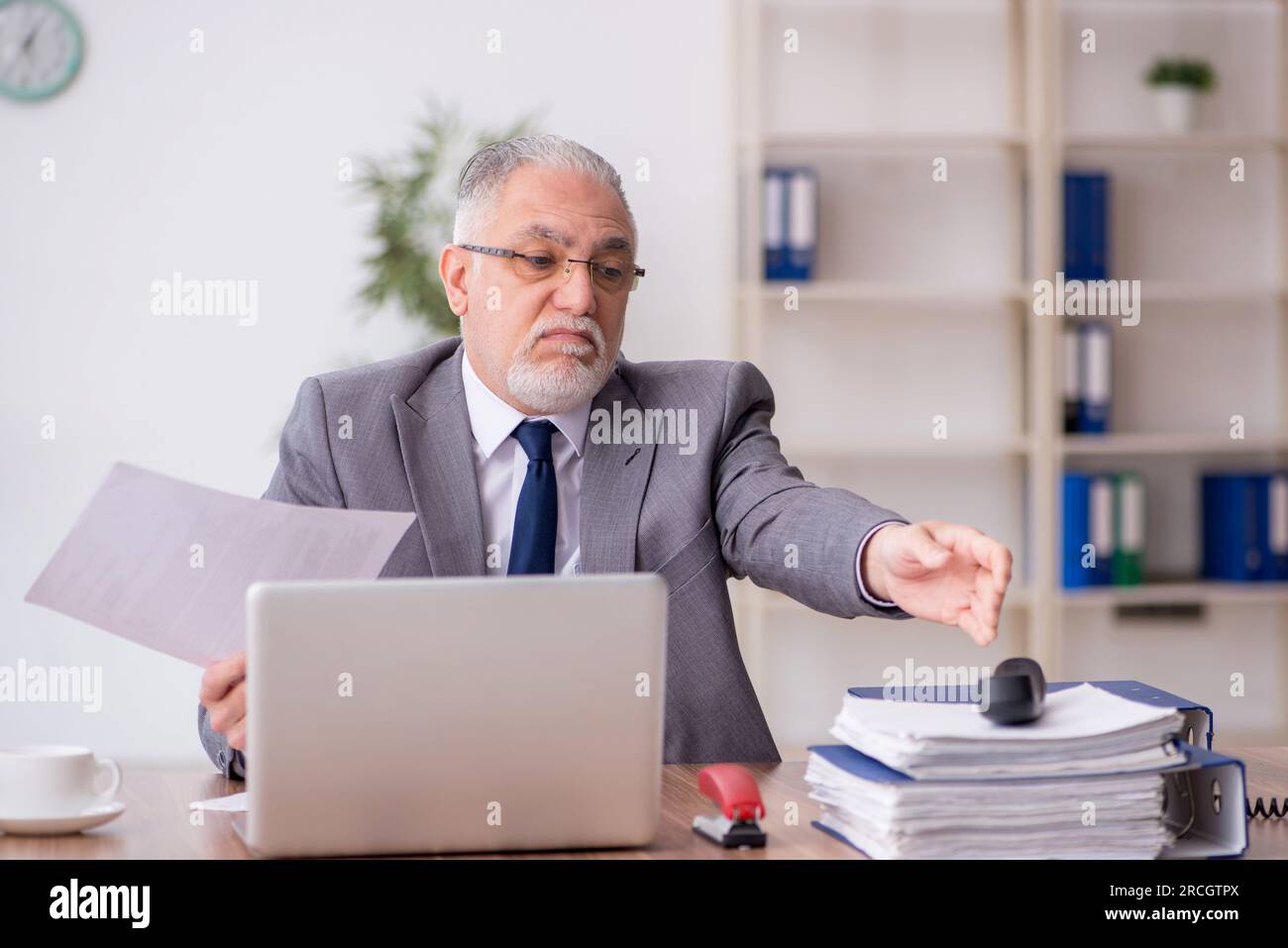 Old employee working in the office Stock Photo - Alamy