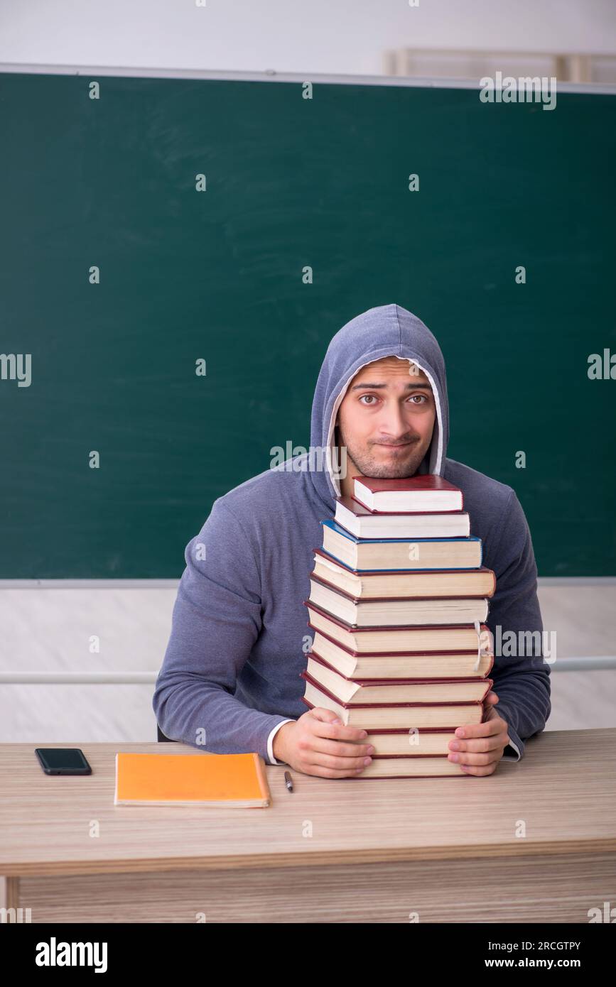 Young student sitting in the classroom Stock Photo - Alamy