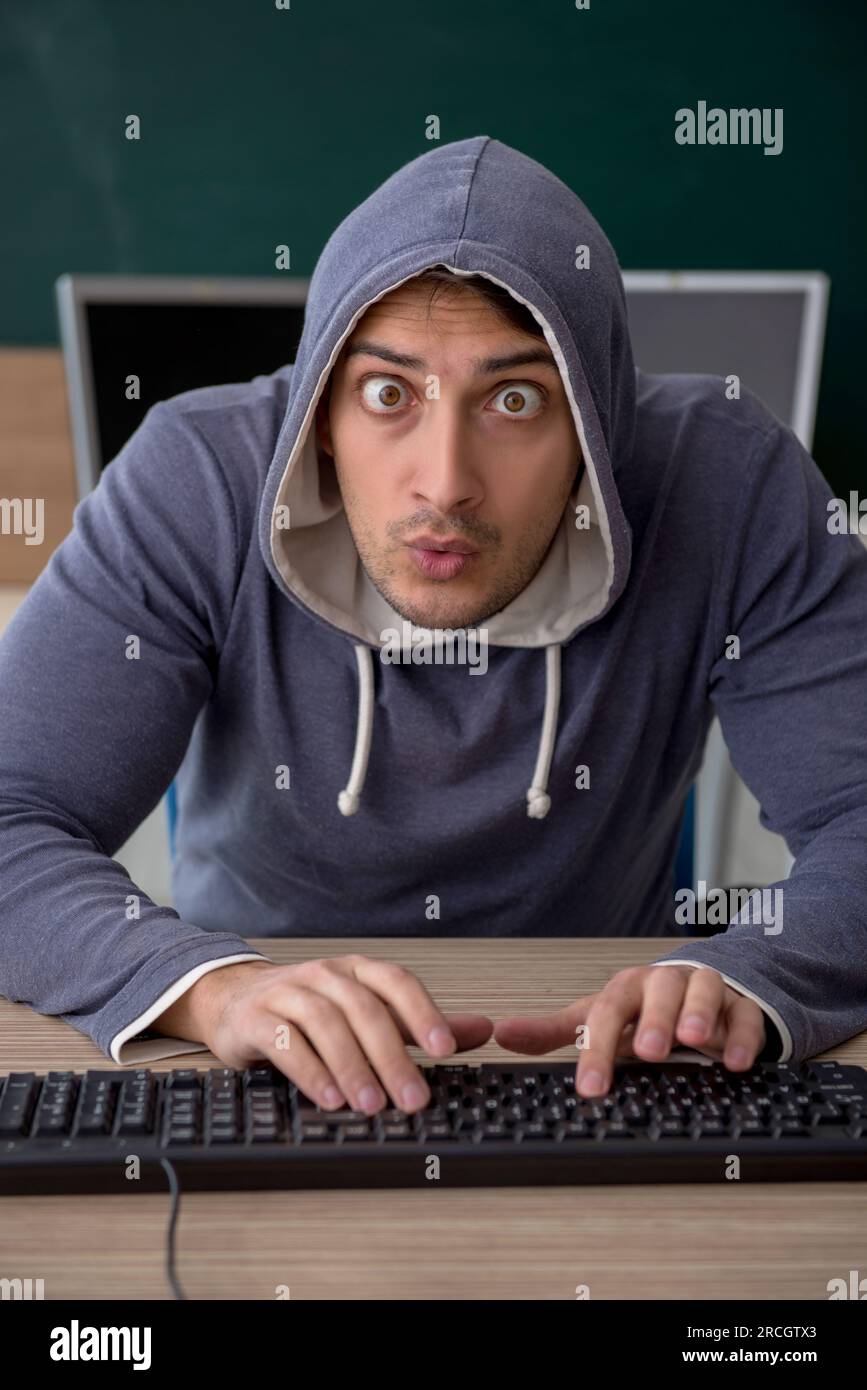 Hacker sitting computer cracking hi-res stock photography and images ...