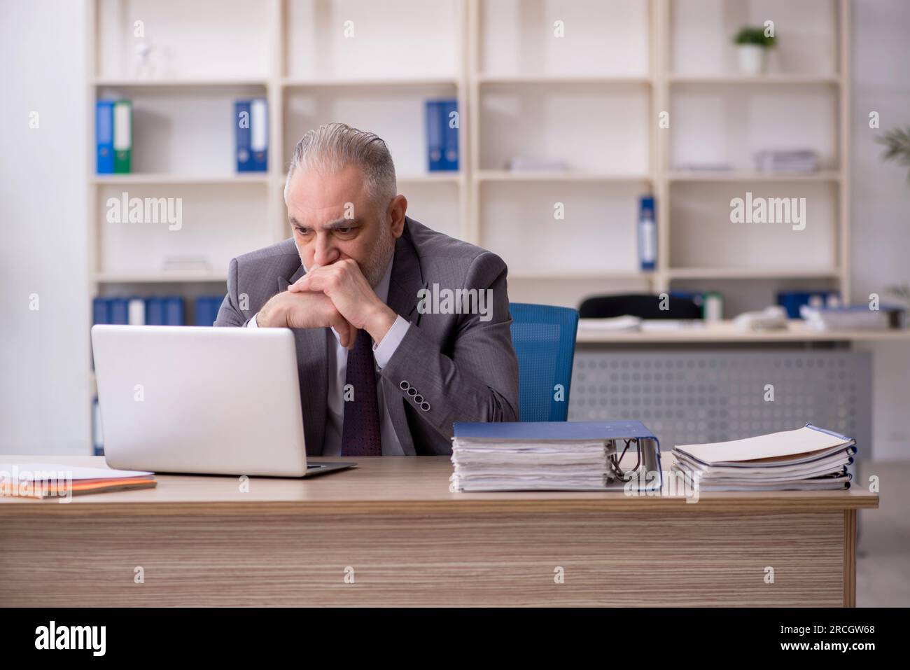 Old employee working in the office Stock Photo - Alamy