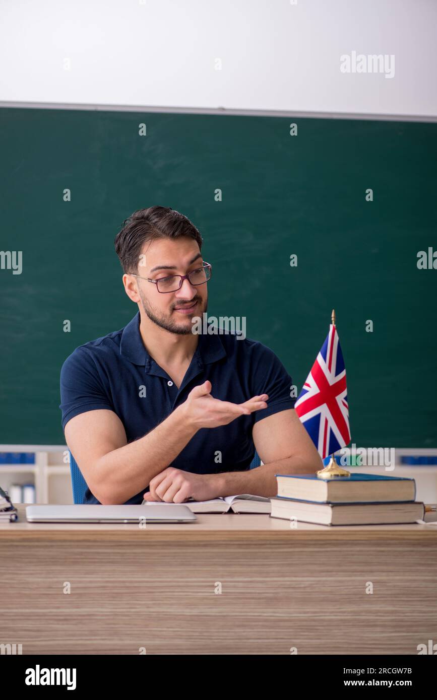 English language teacher in front of green board Stock Photo - Alamy