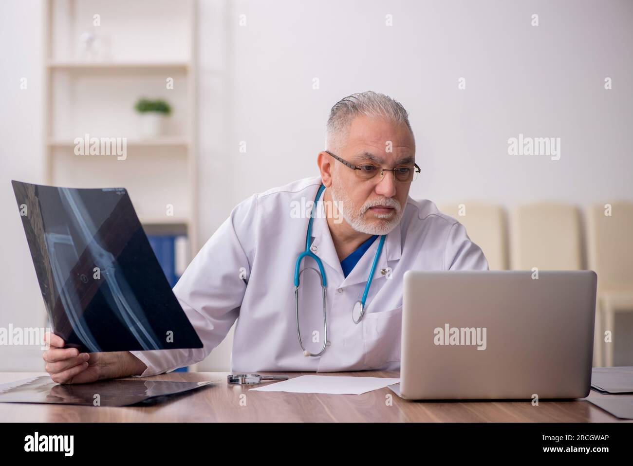 Old doctor radiologist working in the clinic Stock Photo - Alamy