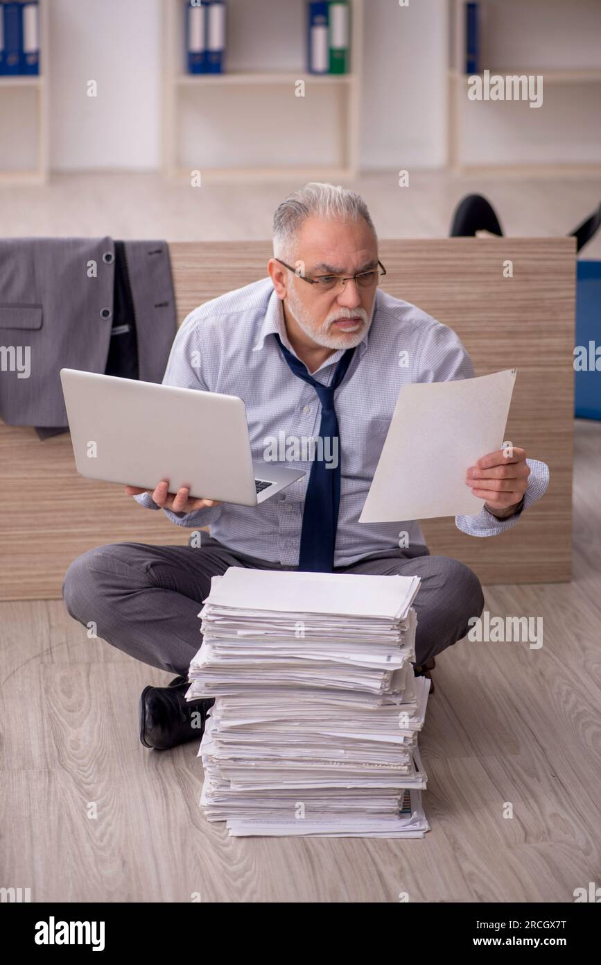 Old businessman reading documents in hi-res stock photography and ...