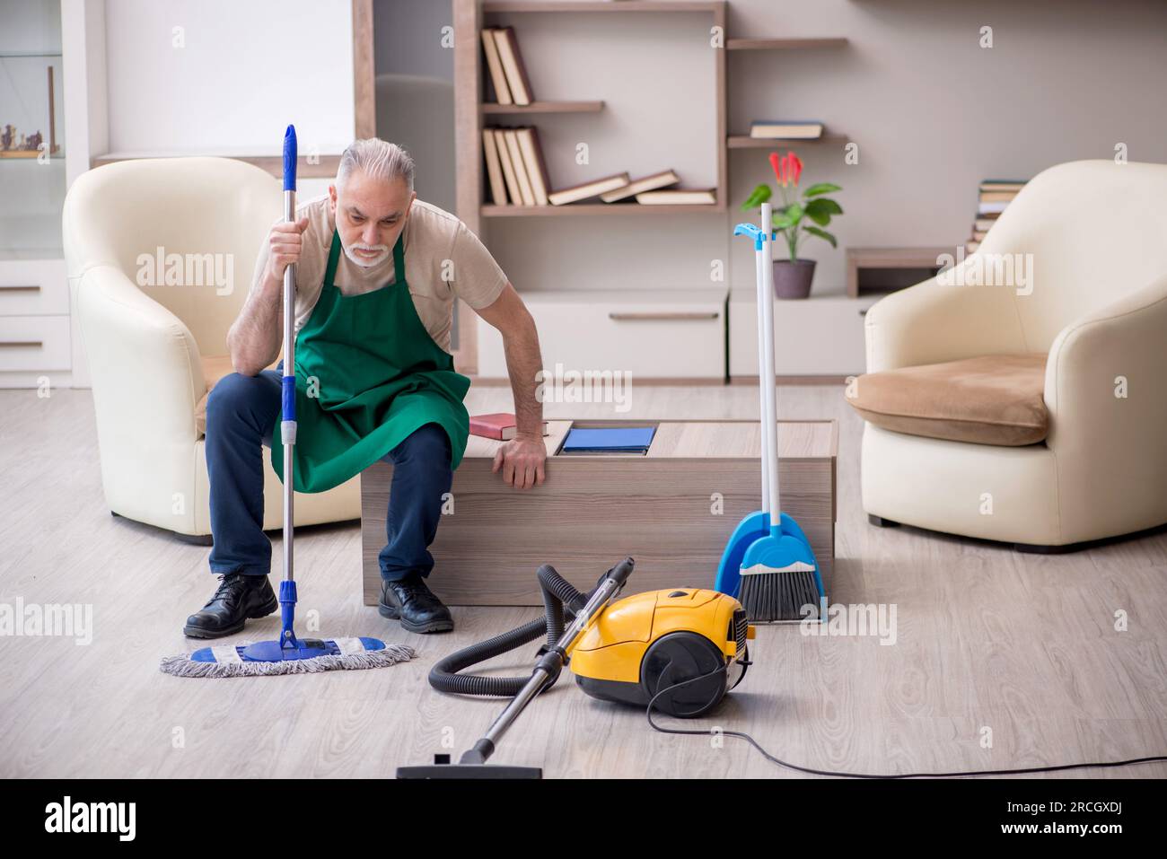 Old contractor cleaning the house Stock Photo - Alamy