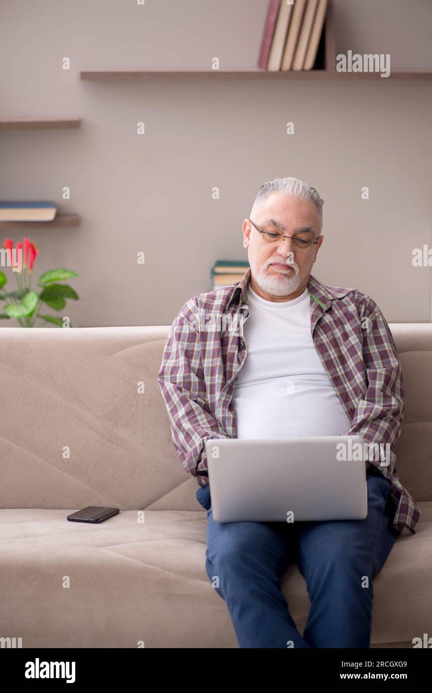 Old man working from home Stock Photo - Alamy