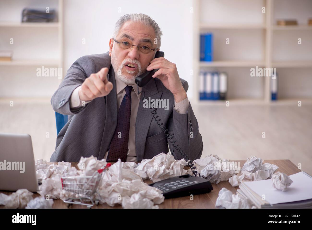 Old employee in brainstorming concept Stock Photo - Alamy