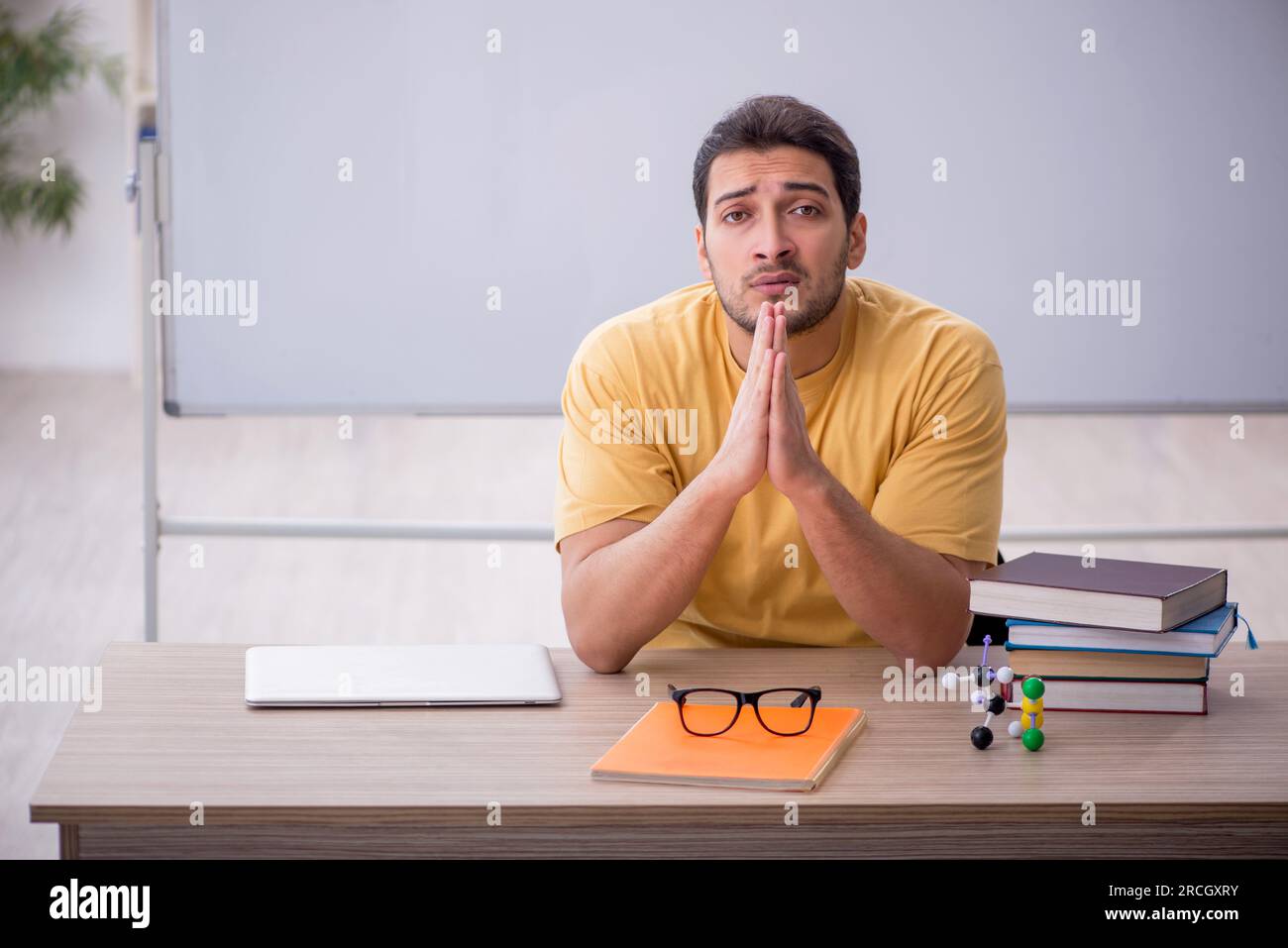 Young student sitting in the classroom Stock Photo - Alamy