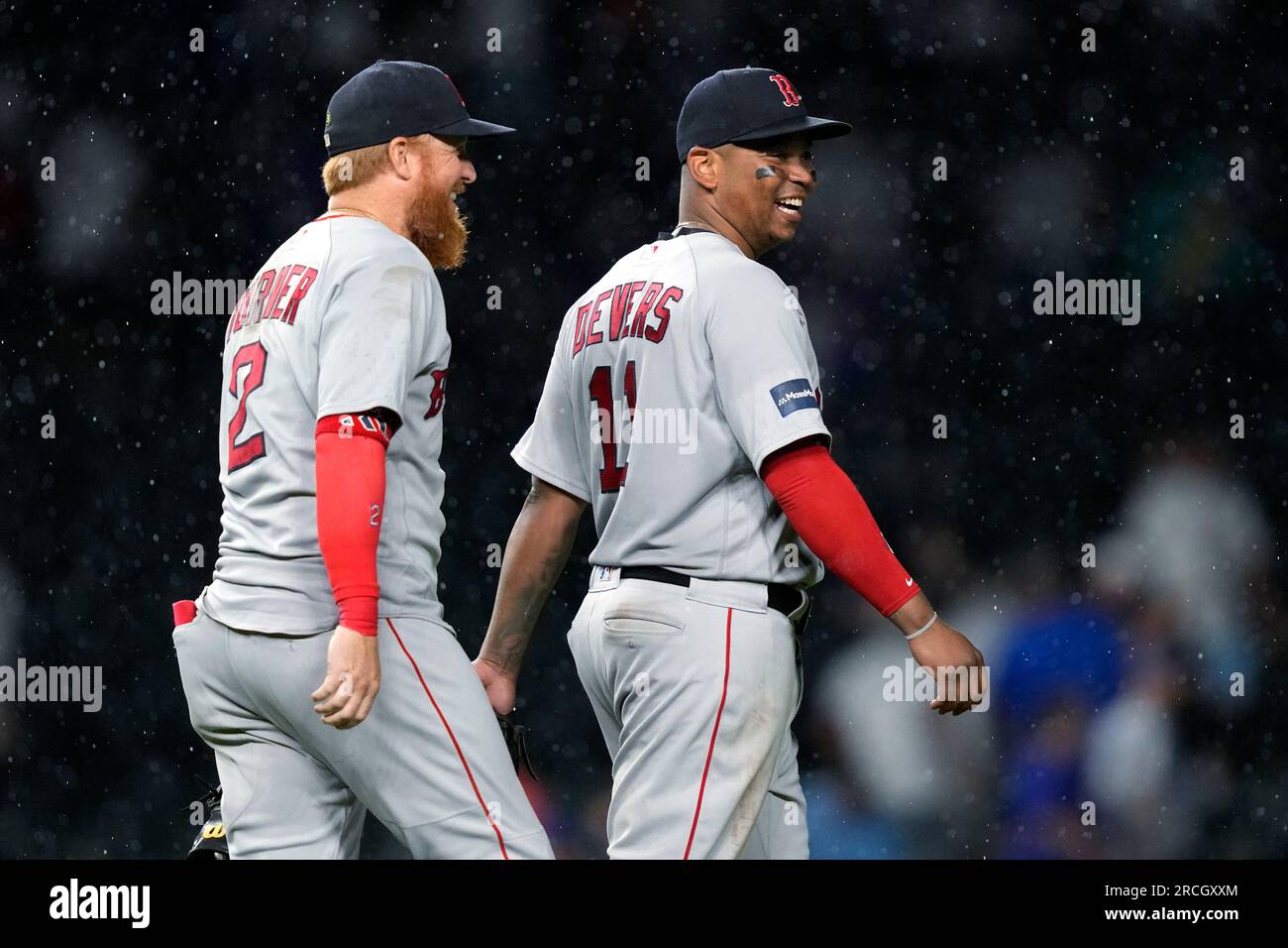 Boston Red Sox's Justin Turner and Rafael Devers smile after the team's ...