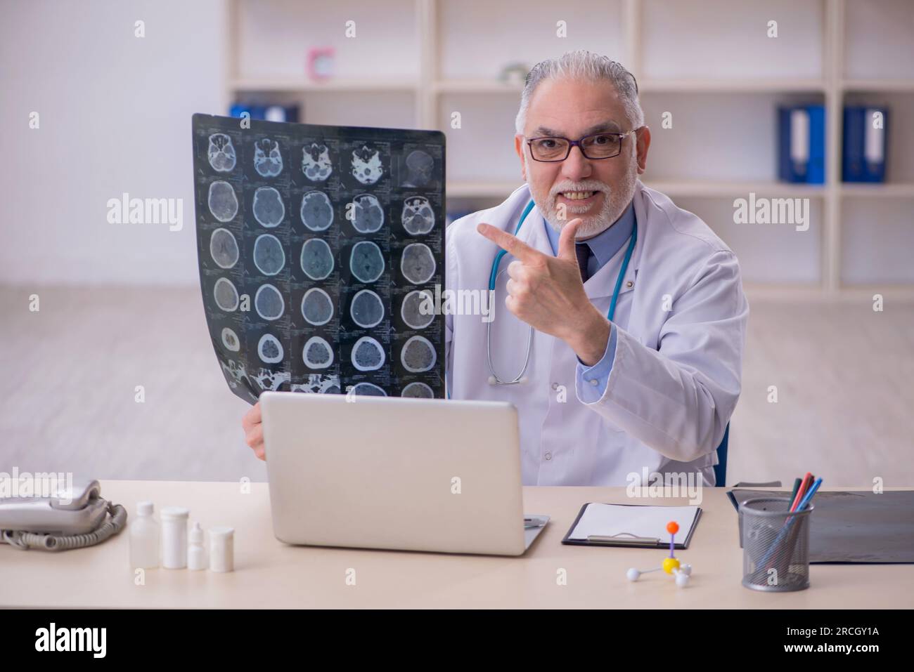Old doctor radiologist working in the clinic Stock Photo - Alamy