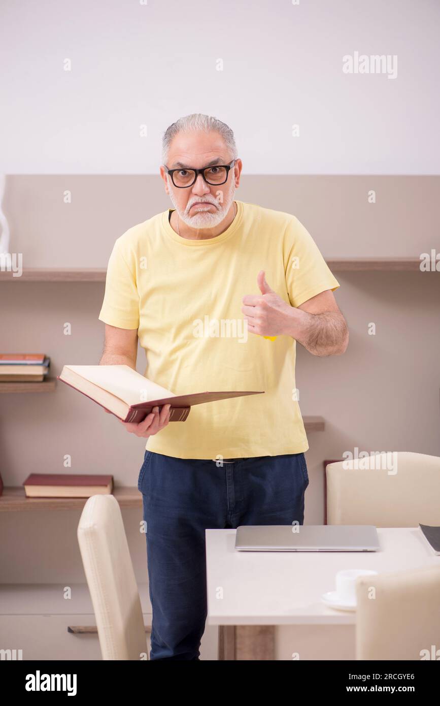 Old man cleaning the house Stock Photo - Alamy