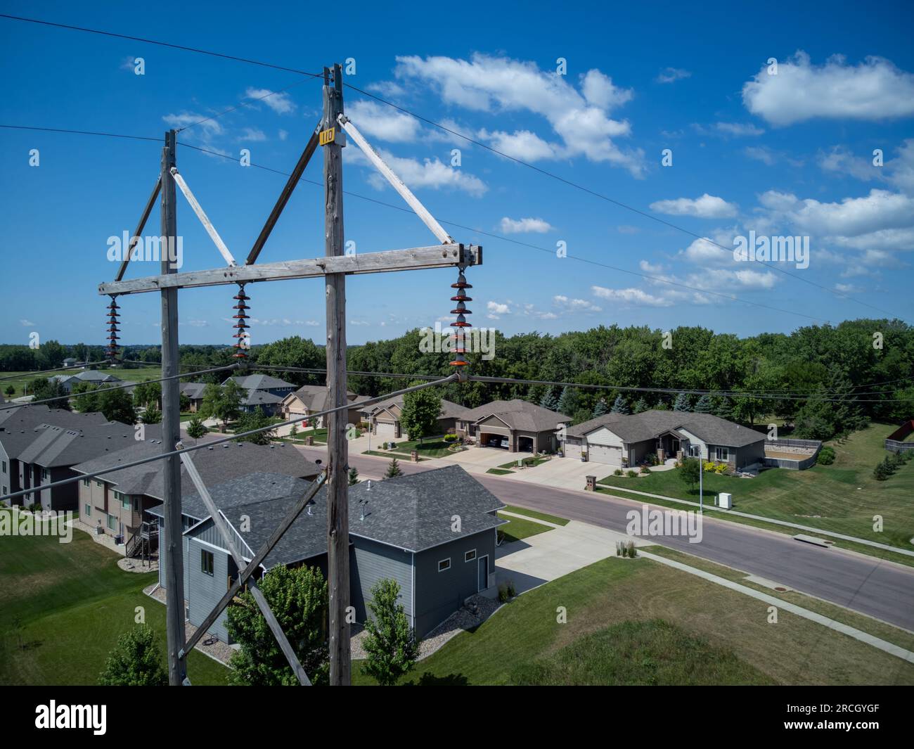 Drone aerial view of high voltage power lines through a residential ...