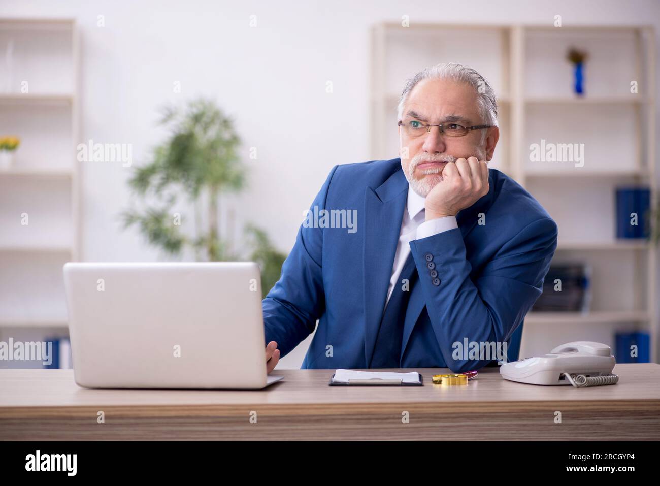 Old boss working in the office Stock Photo - Alamy