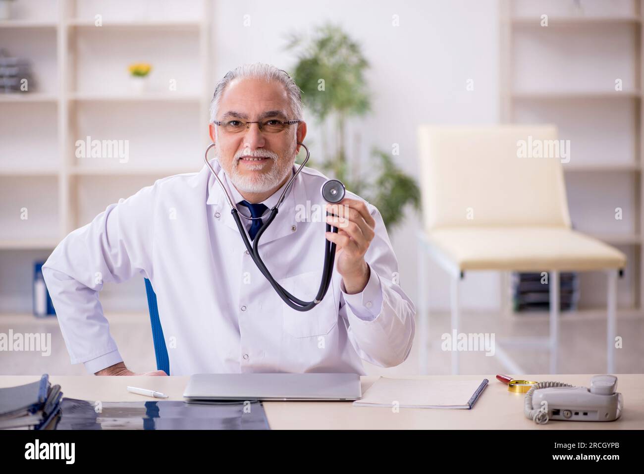 Old doctor working at the hospital Stock Photo - Alamy