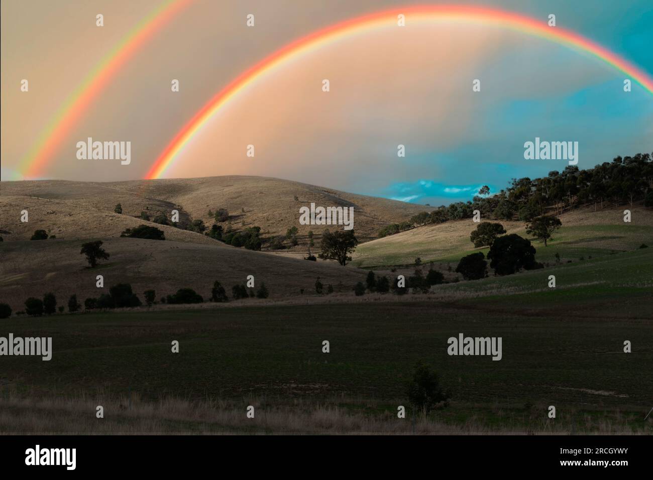Double rainbow over the hill Stock Photo - Alamy