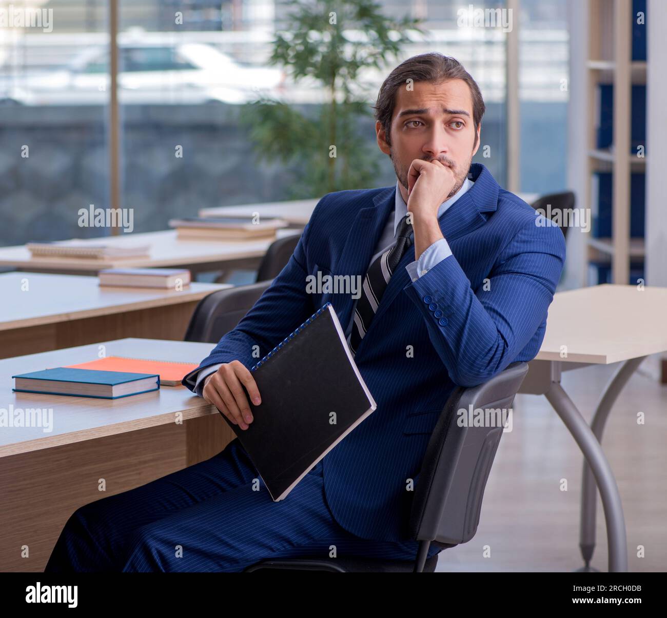 Young teacher in suit in the classroom Stock Photo - Alamy