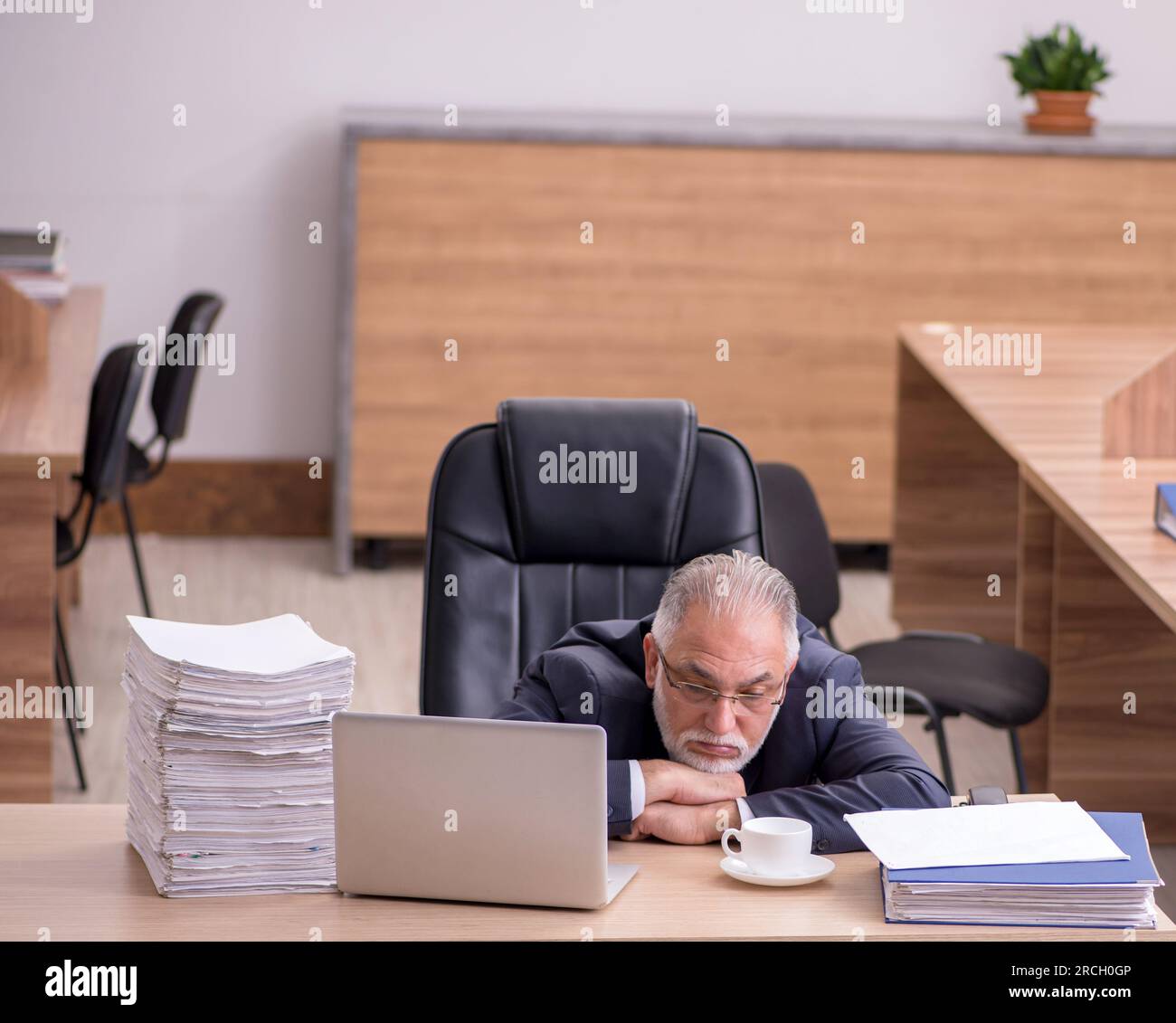 Old employee working in the office Stock Photo - Alamy