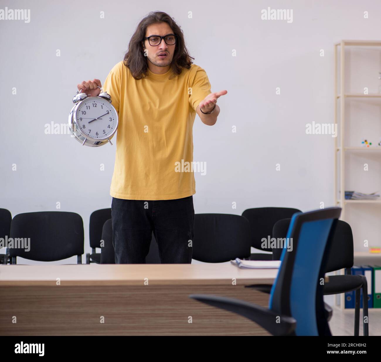 Young student waiting for teacher in the classroom Stock Photo - Alamy