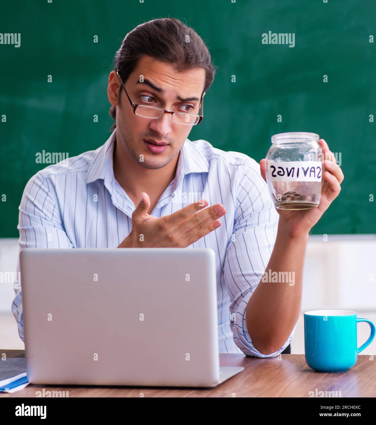 Young teacher in remuneration concept Stock Photo - Alamy