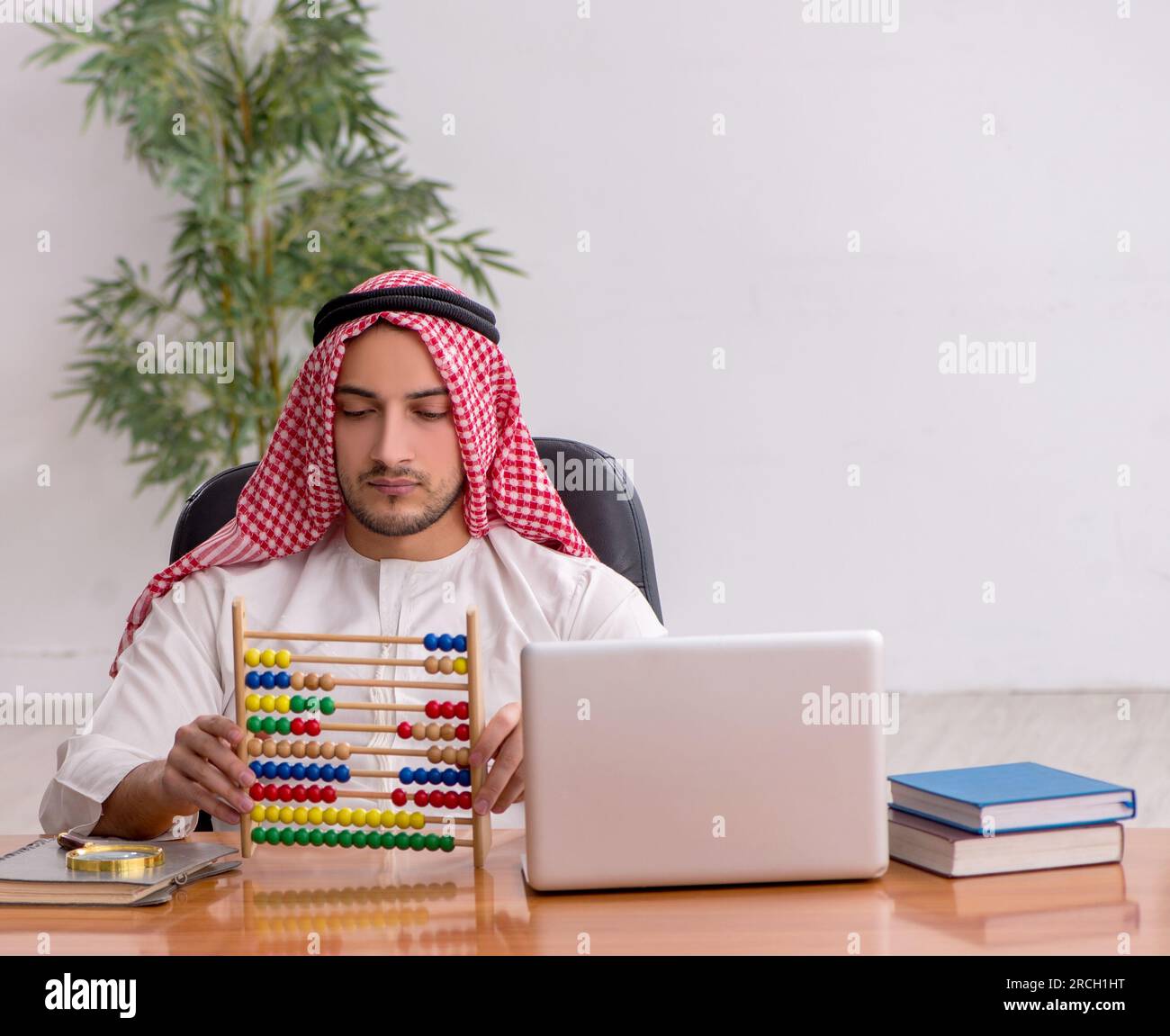 Male arab employee working in the office Stock Photo - Alamy