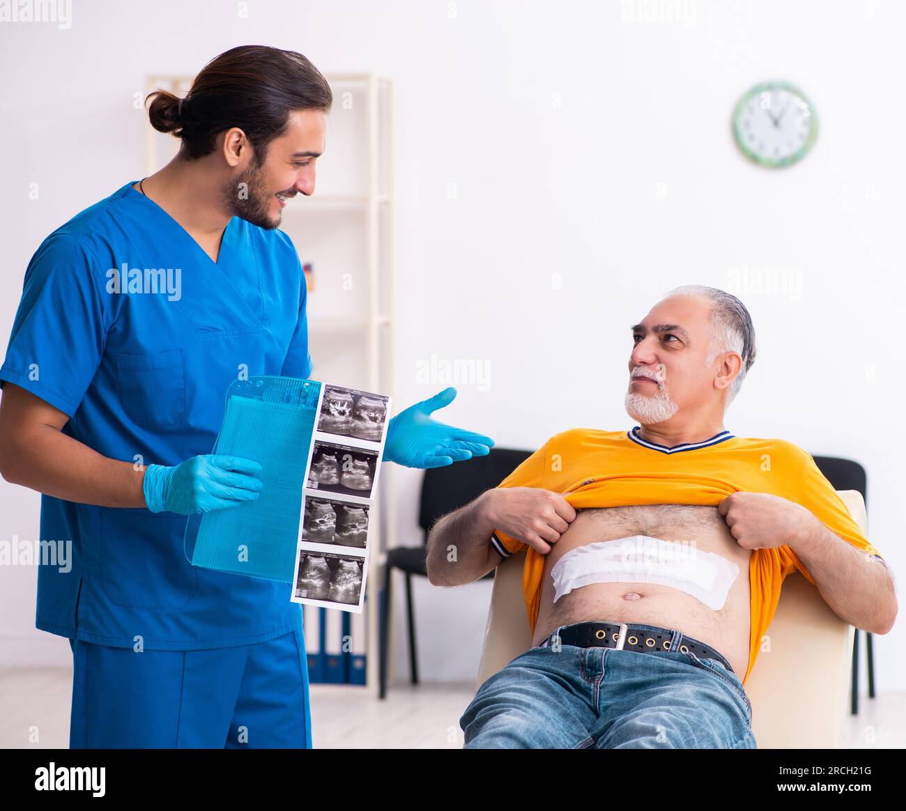 Old man visiting male doctor Stock Photo - Alamy