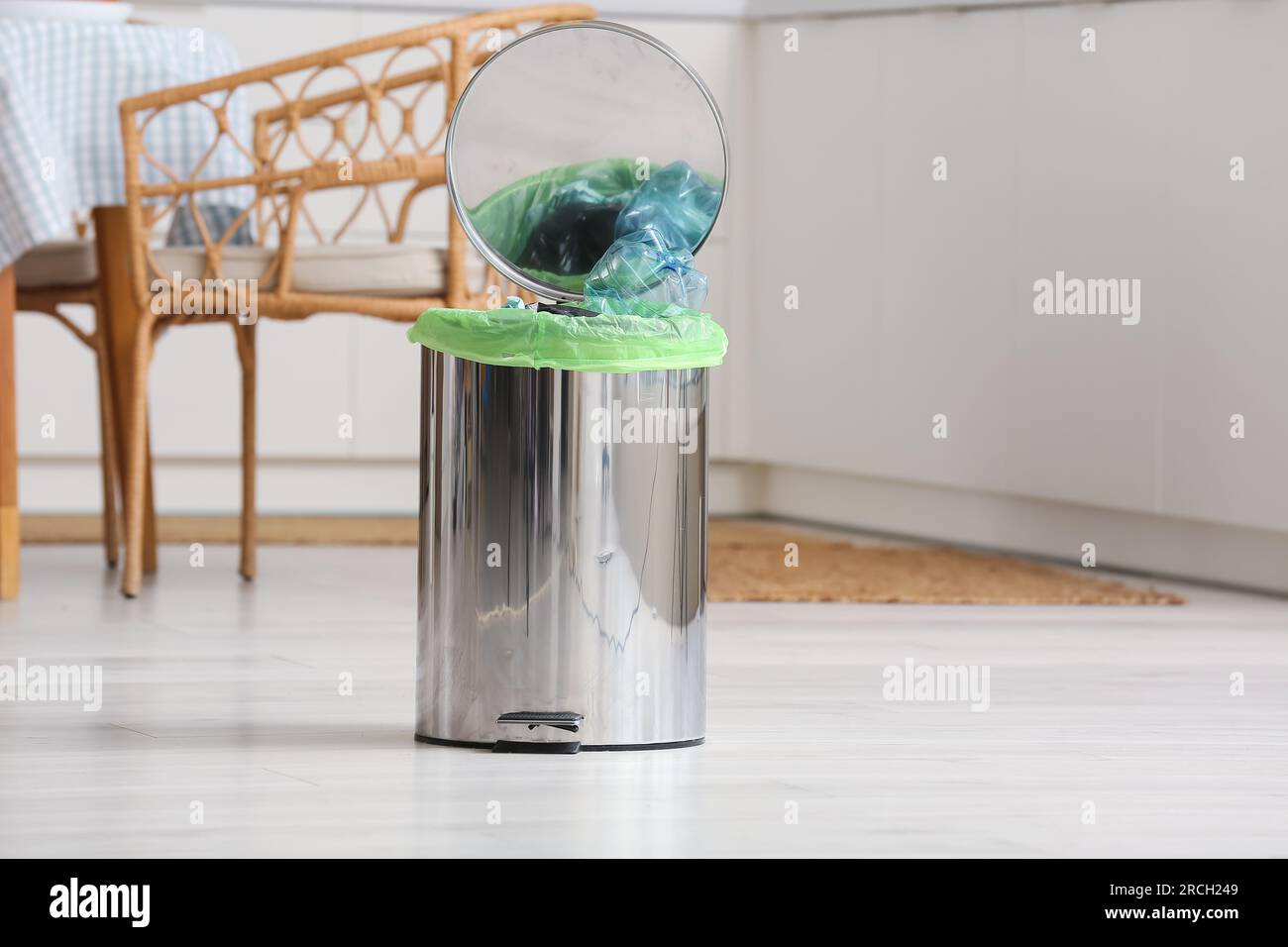 Opened trash bin with garbage in interior of light kitchen Stock Photo ...