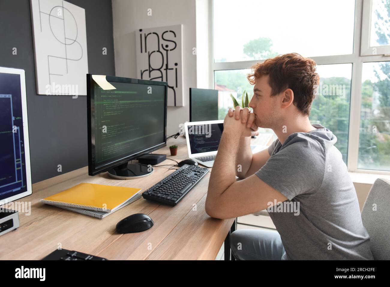 Male programmer working with computer at table in office Stock Photo - Alamy