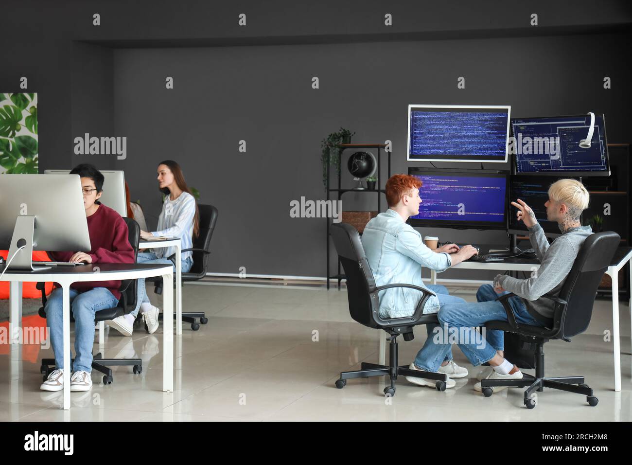 Team of young programmers working in office Stock Photo - Alamy