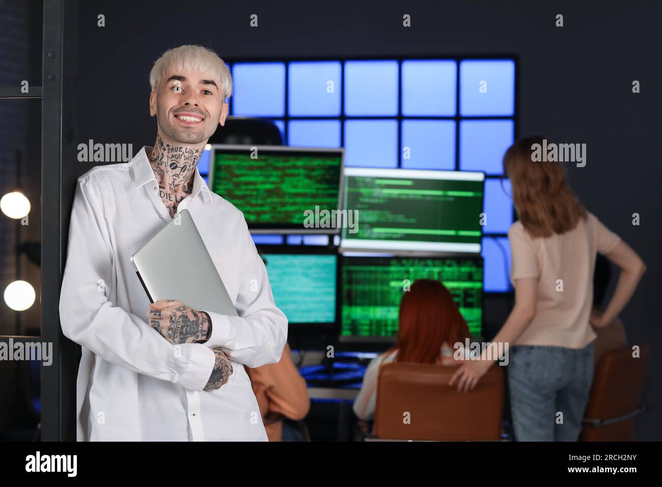 Male programmer with laptop in office at night Stock Photo - Alamy