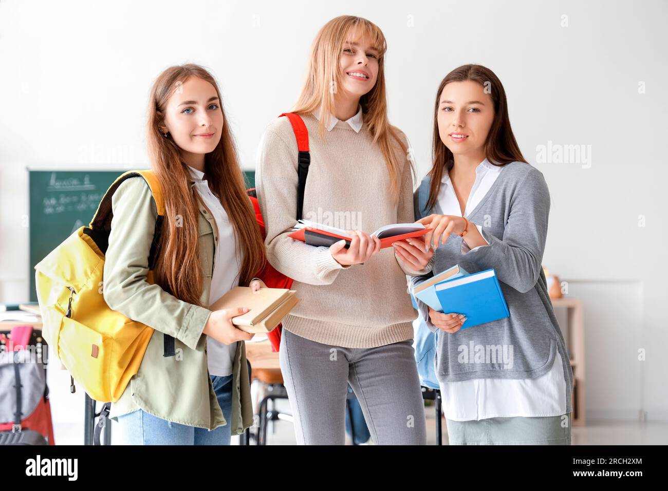 Female students with books in classroom Stock Photo - Alamy