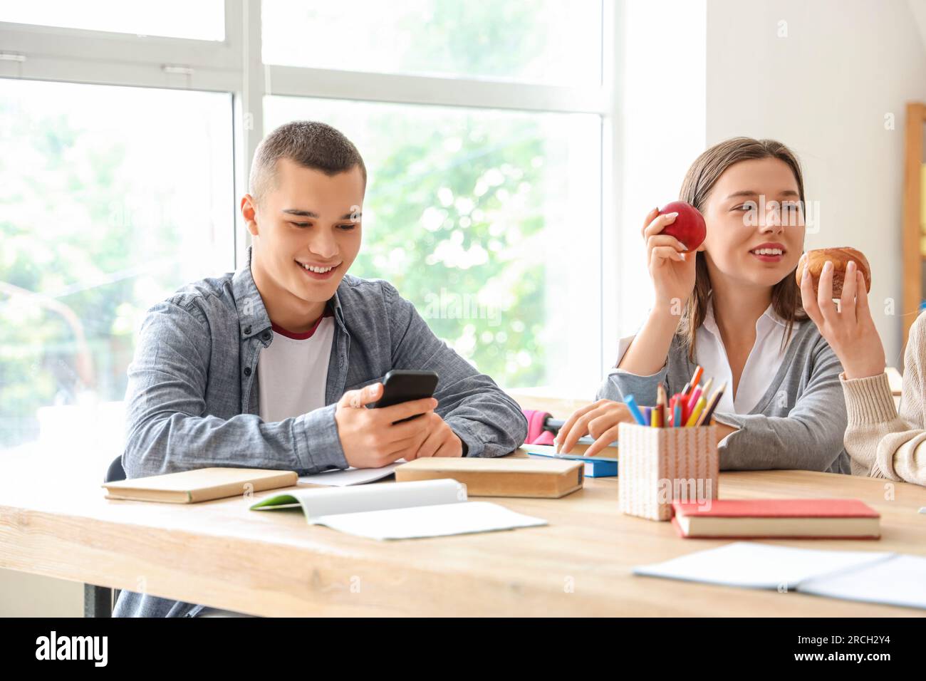 Girl using mobile phone in classroom hi-res stock photography and ...