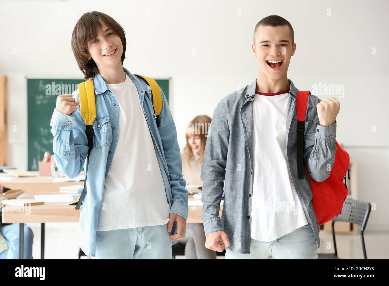 Happy male students in classroom Stock Photo - Alamy
