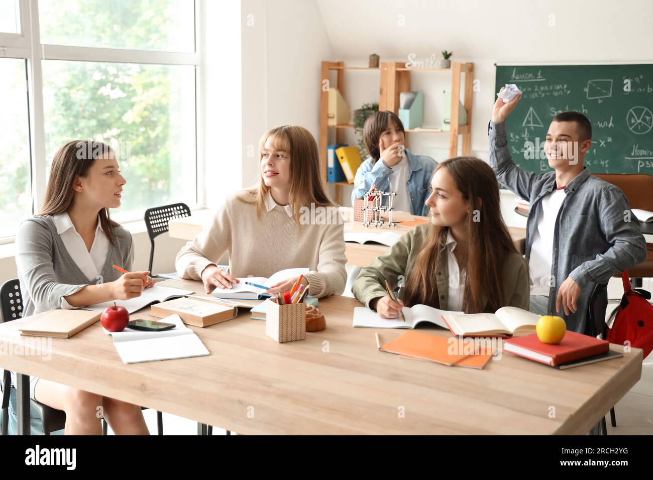 Female students studying at table in classroom Stock Photo - Alamy