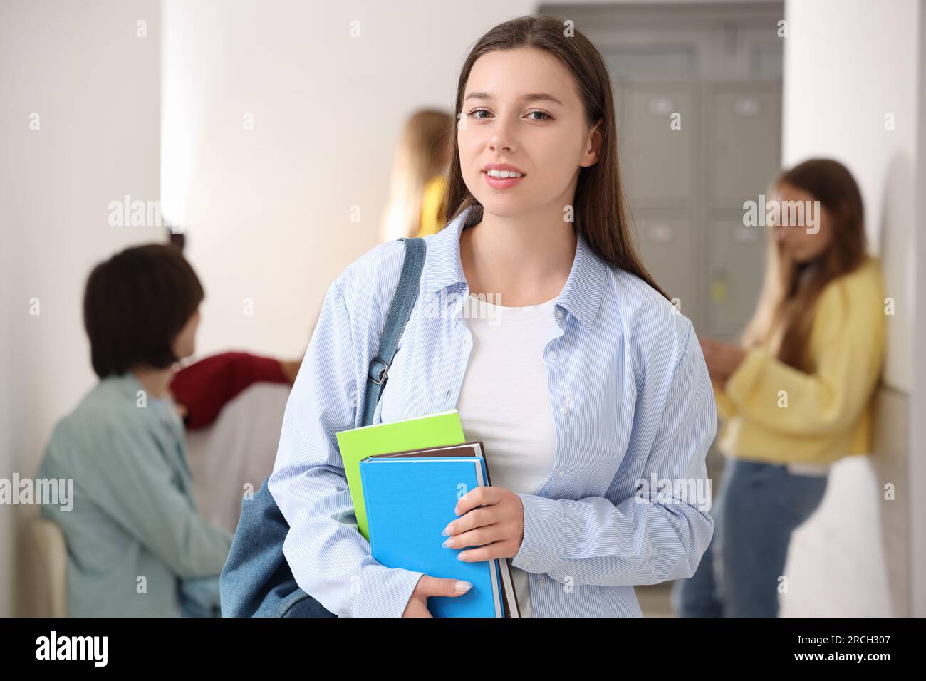 Teenage girl with copybooks at school Stock Photo - Alamy