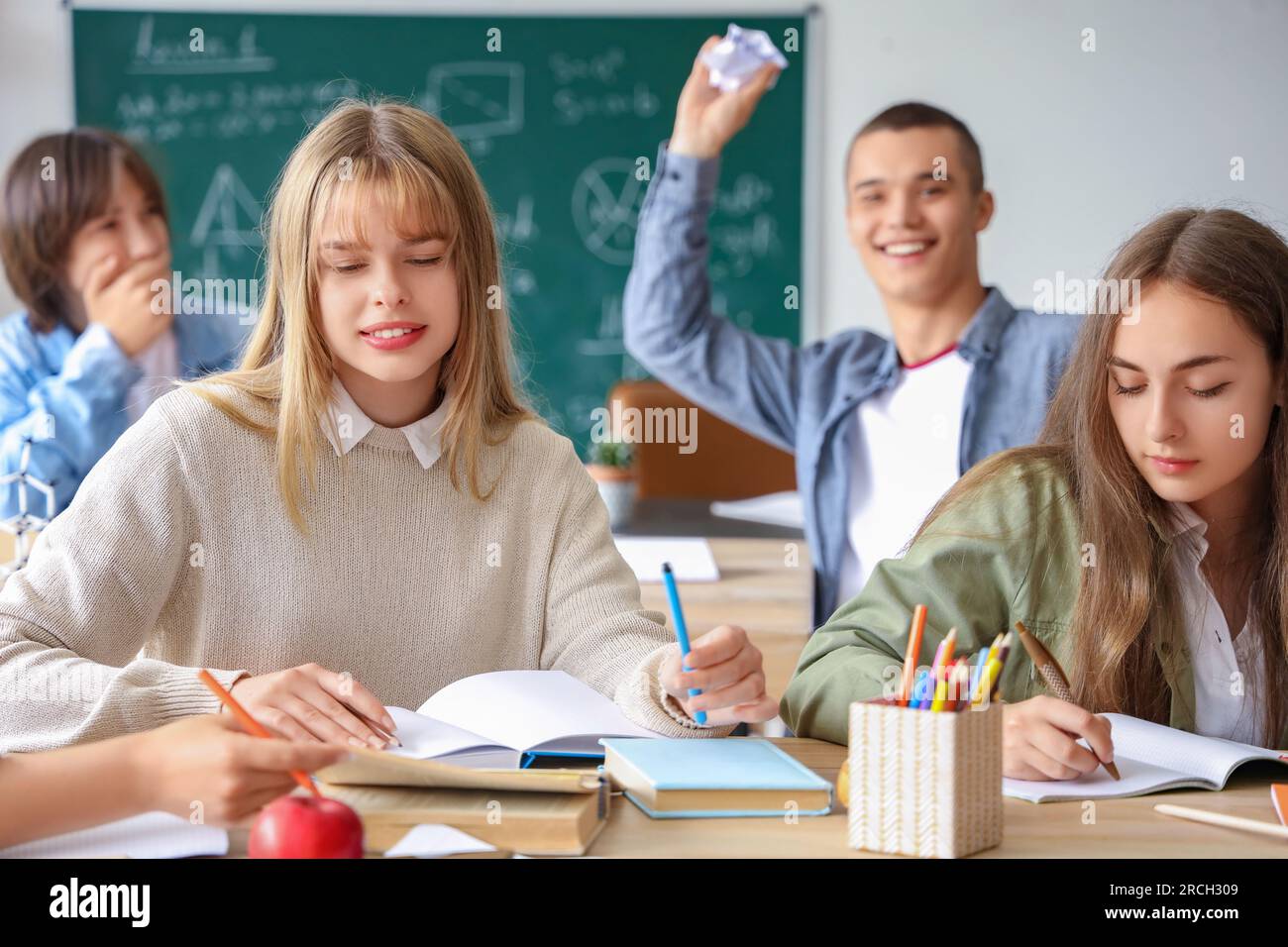 Female students studying at table in classroom Stock Photo - Alamy