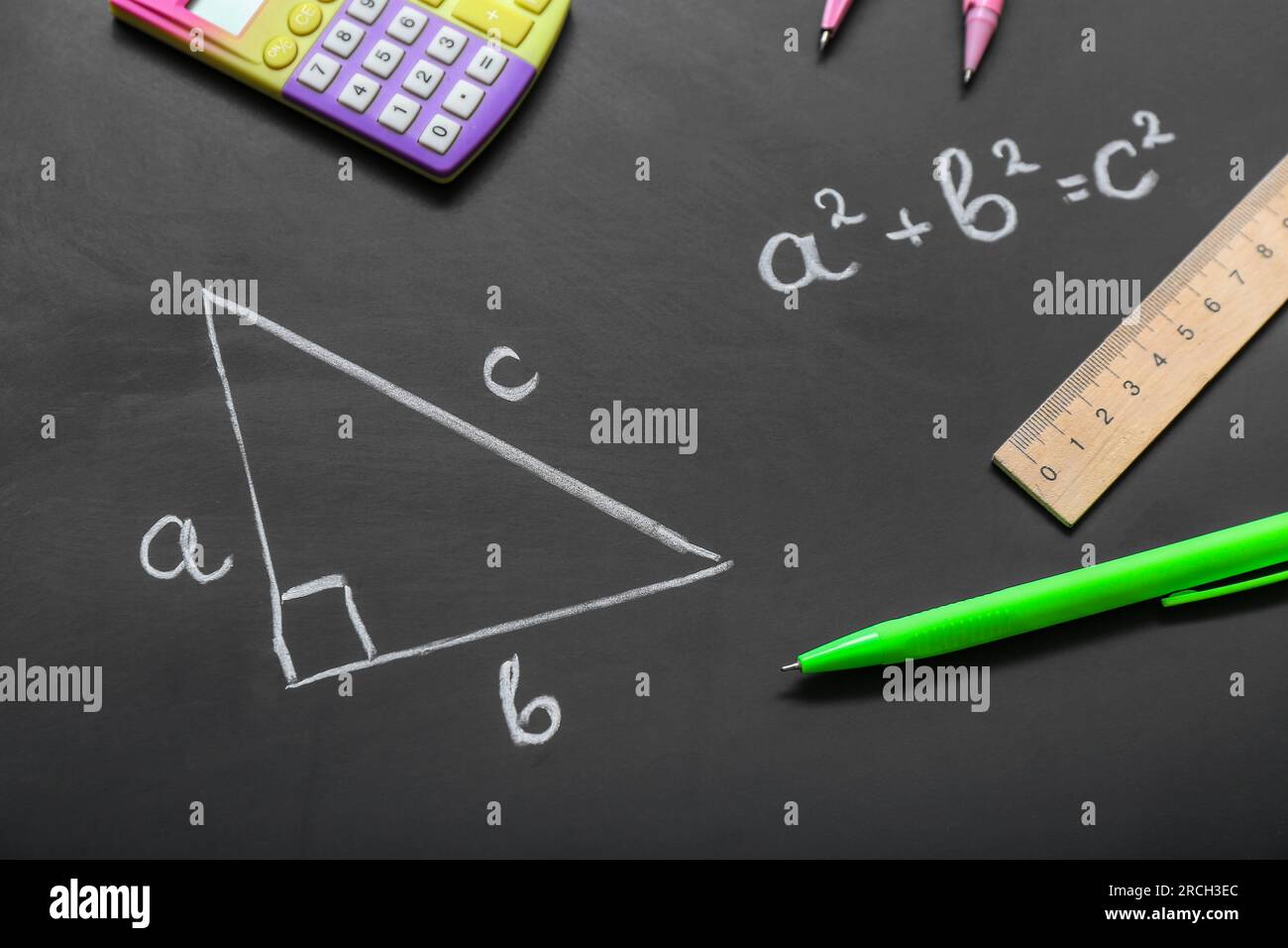 Different stationery on black chalkboard with formulas Stock Photo - Alamy