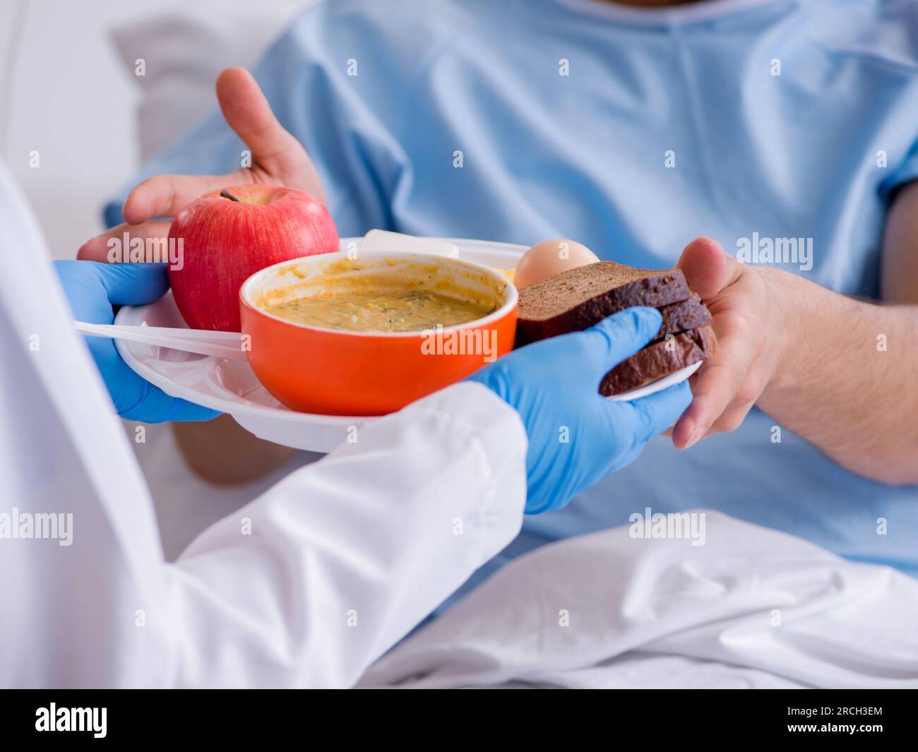 The male patient eating food in the hospital Stock Photo - Alamy