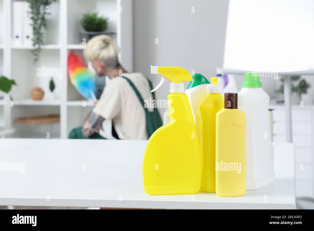 Bottles of detergent on table in office, closeup Stock Photo - Alamy