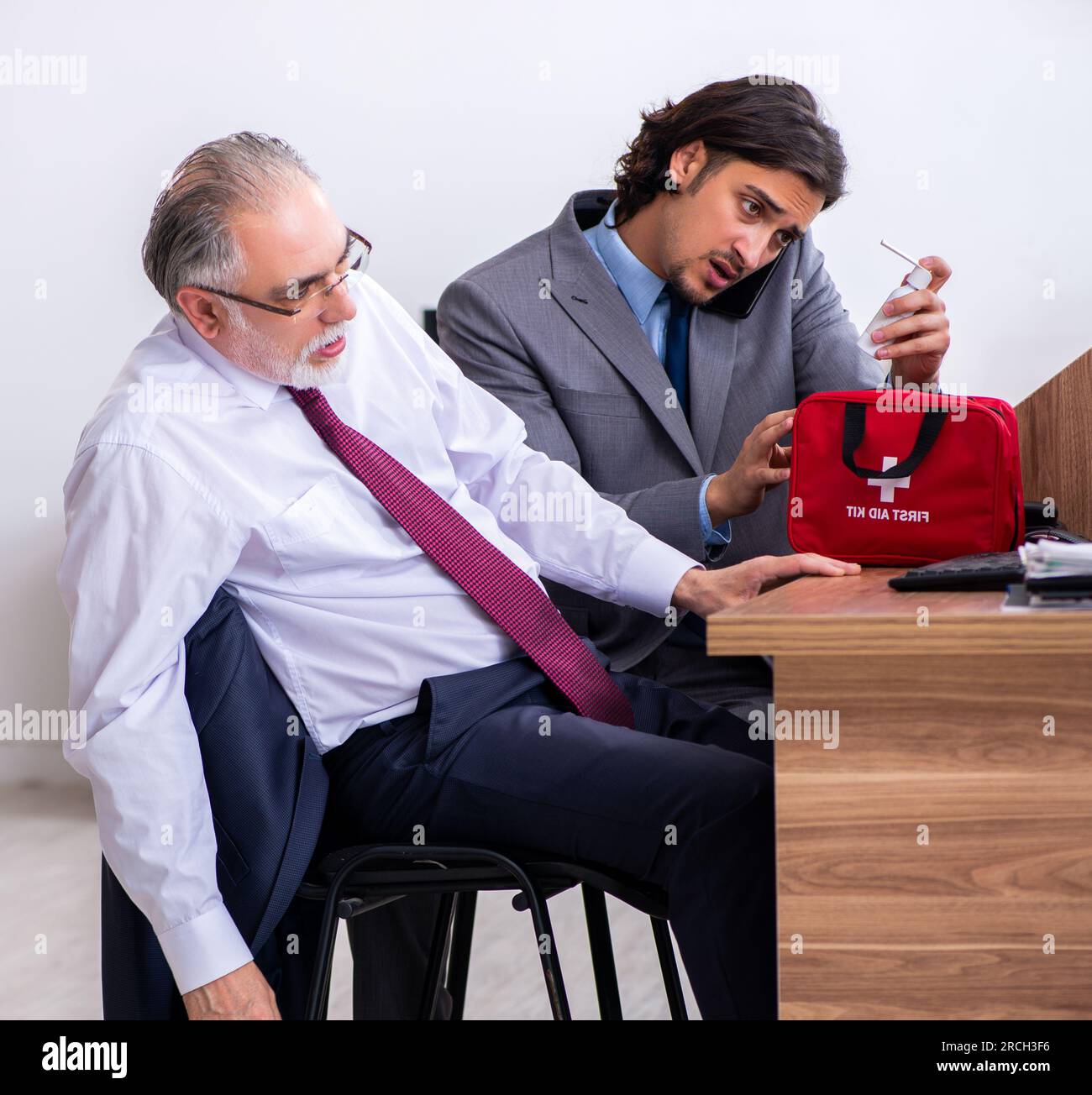 The male employee suffering from heart attack in the office Stock Photo ...