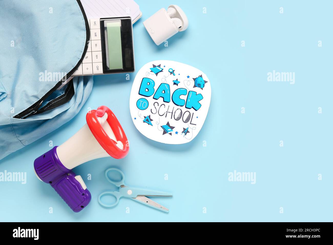 Backpack, stationery, earphones, megaphone and sheet with text BACK TO ...