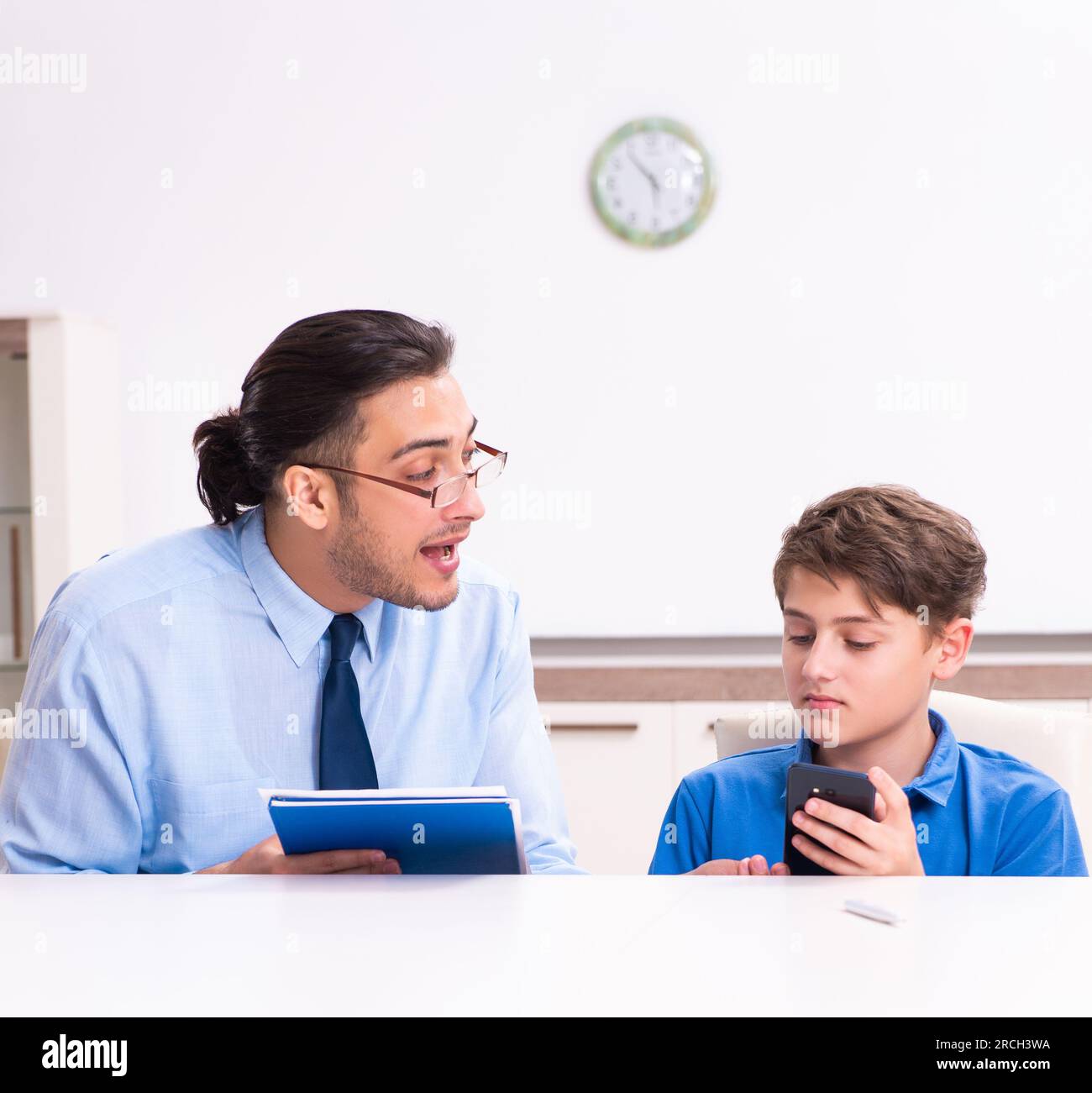 The busy father helping his son to prepare for exam Stock Photo - Alamy