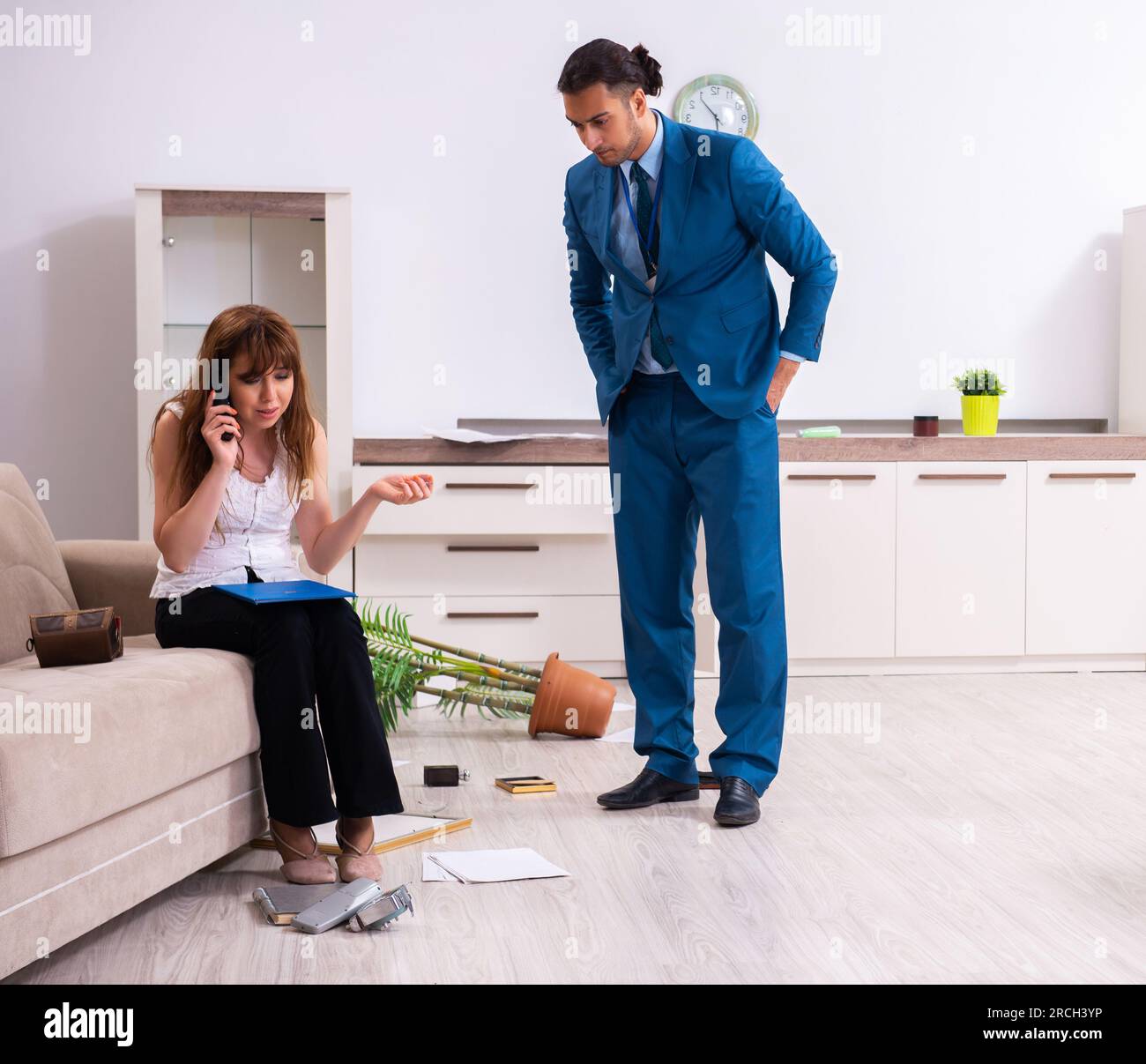 Female owner and police officer in housebreaking concept Stock Photo ...