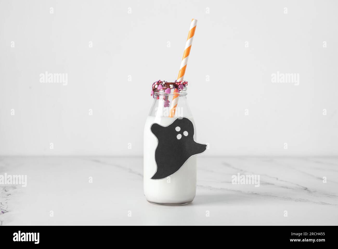 Bottle of milk, ghost made of paper and sprinkles for Halloween on ...