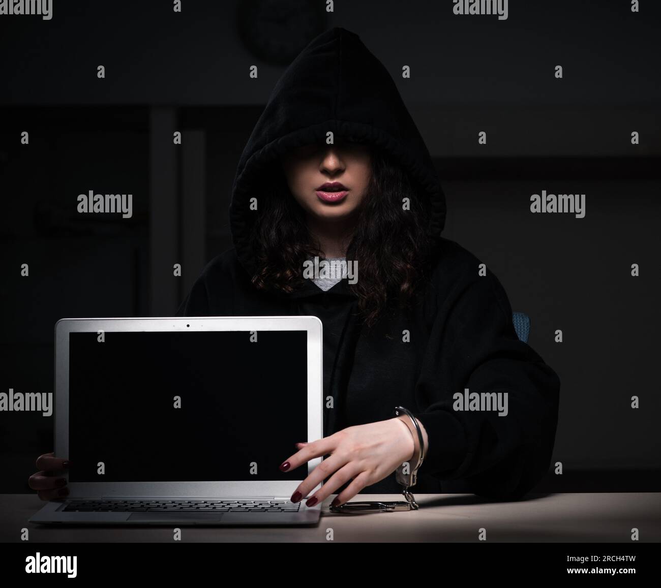 The female hacker hacking security firewall late in office Stock Photo ...